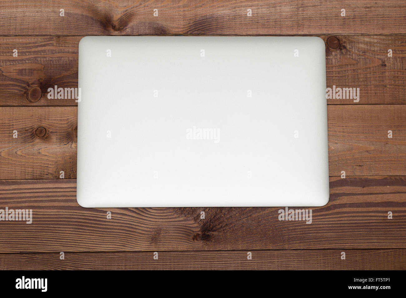 Closed silver laptop on brown wooden table, top view Stock Photo - Alamy