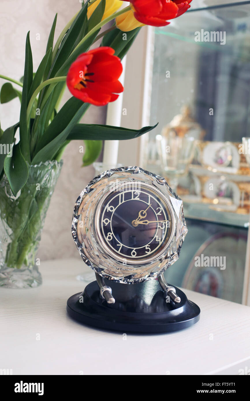 Very old retro antique clock with glass on white table in living room ...