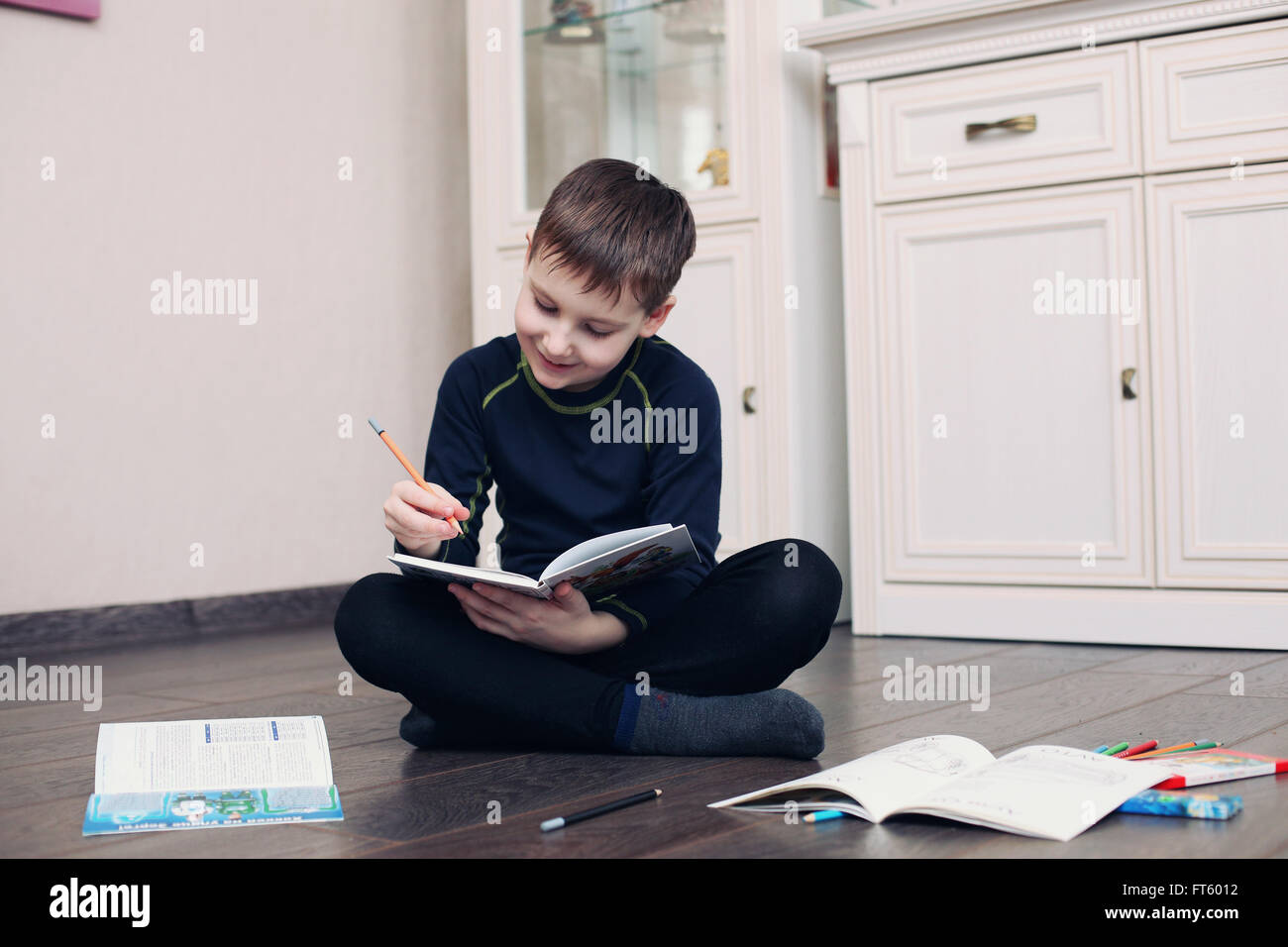 Child sitting floor notebook thinking hi-res stock photography and ...