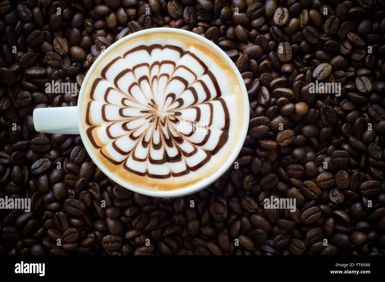 Closeup of a beautiful cup of latte art on coffee bean background Stock ...