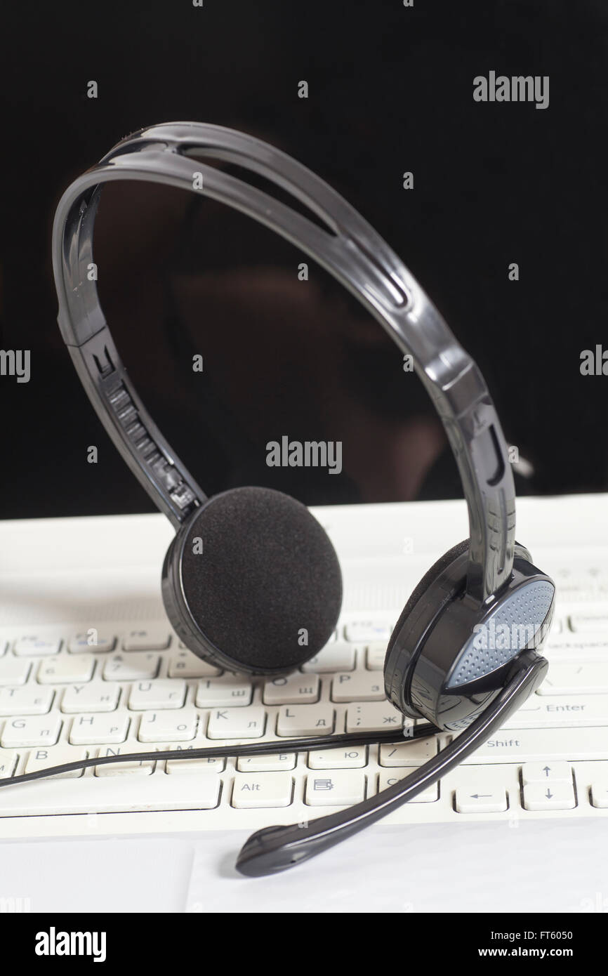 Headset on laptop computer keyboard.Communication concept Stock Photo ...