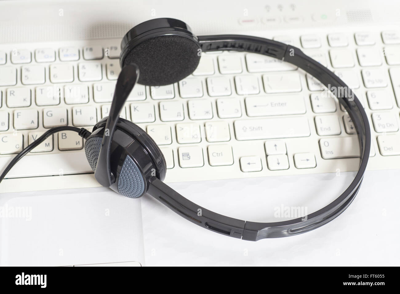Headset on laptop computer keyboard.Communication concept Stock Photo ...