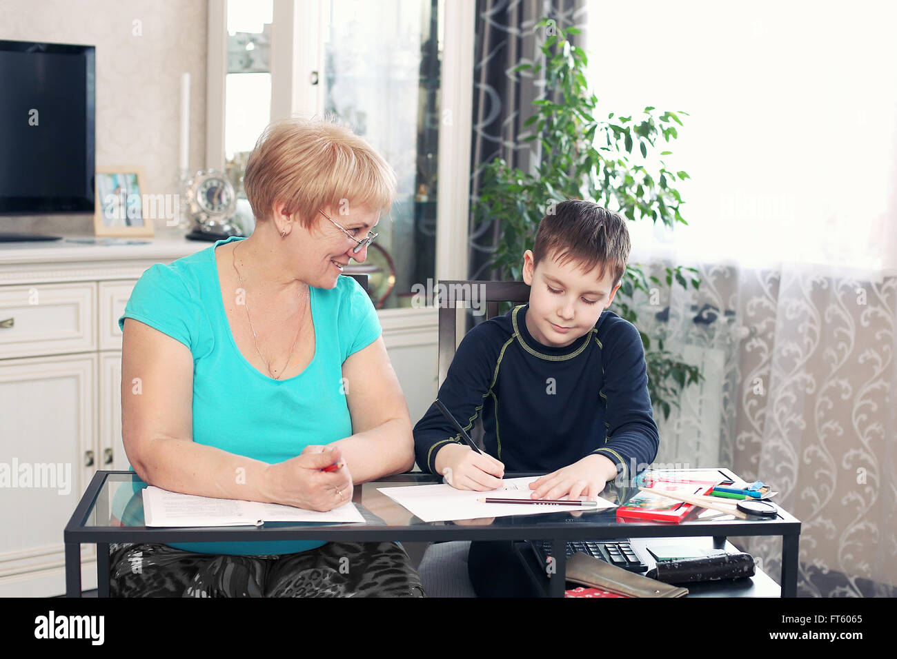the little boy does homework with the grandmother Stock Photo - Alamy the little boy does homework with the grandmother Stock Photo - Alamy