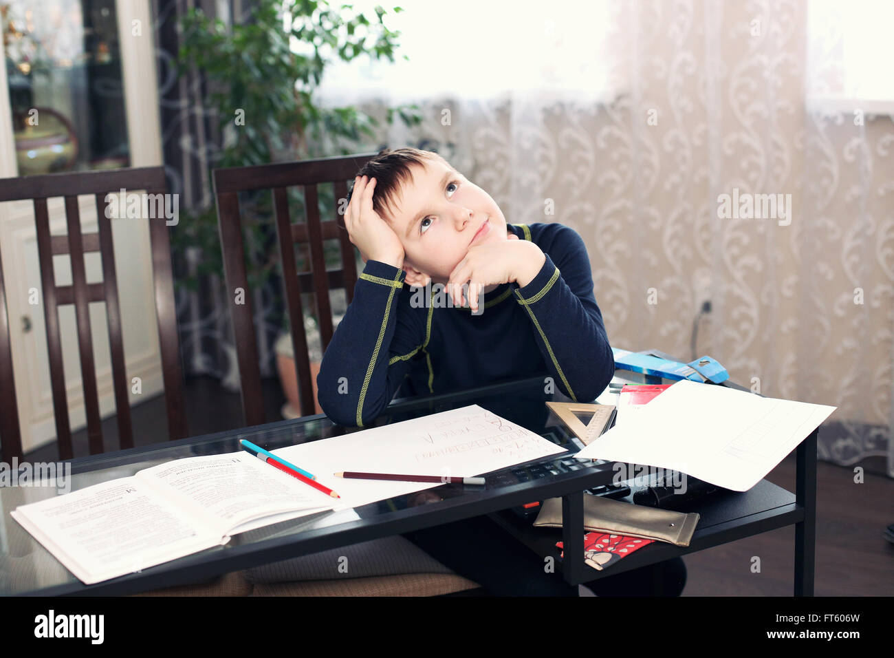 the boy diligently thinks over homework Stock Photo - Alamy