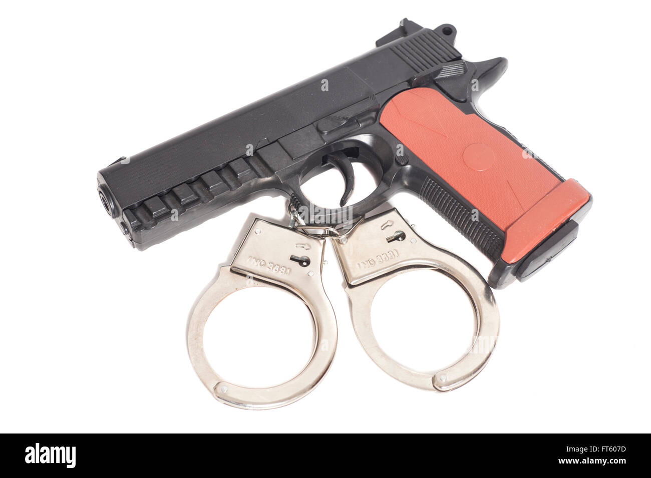 Gun and handcuffs isolated on white background Stock Photo - Alamy
