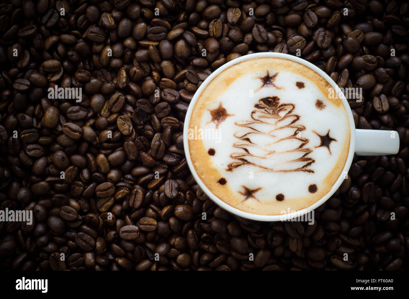 Closeup of a beautiful cup of latte art on coffee bean background Stock ...