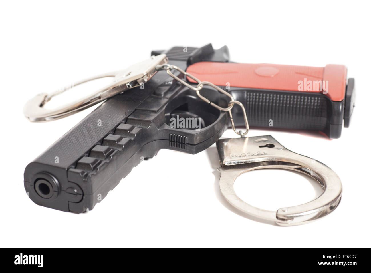 Gun and handcuffs isolated on white background Stock Photo - Alamy