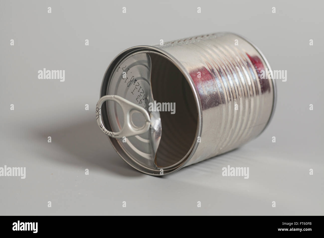 Open an empty tin can on gray background Stock Photo - Alamy