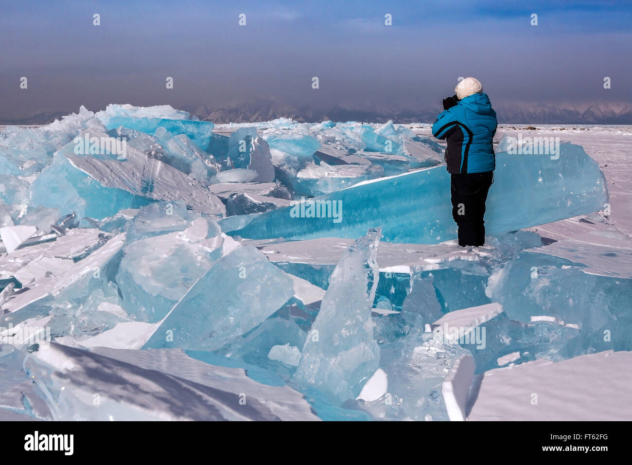 Clumps of blue ice on the snow Stock Photo - Alamy