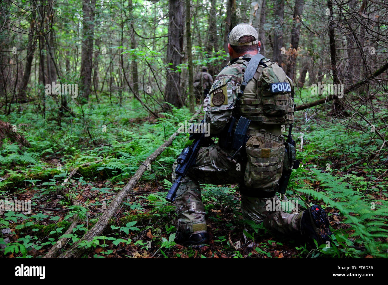 A BORTAC team member coordinates with his team during the manhunt for ...