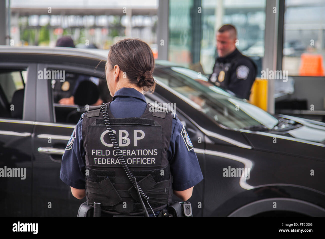 This photograph shows a U.S. Customs and Border Protection officer ...