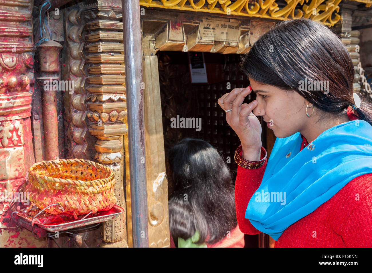 Nepal, Kathmandu. Hindu Woman Applying Bindi of Kumkuma Powder to ...
