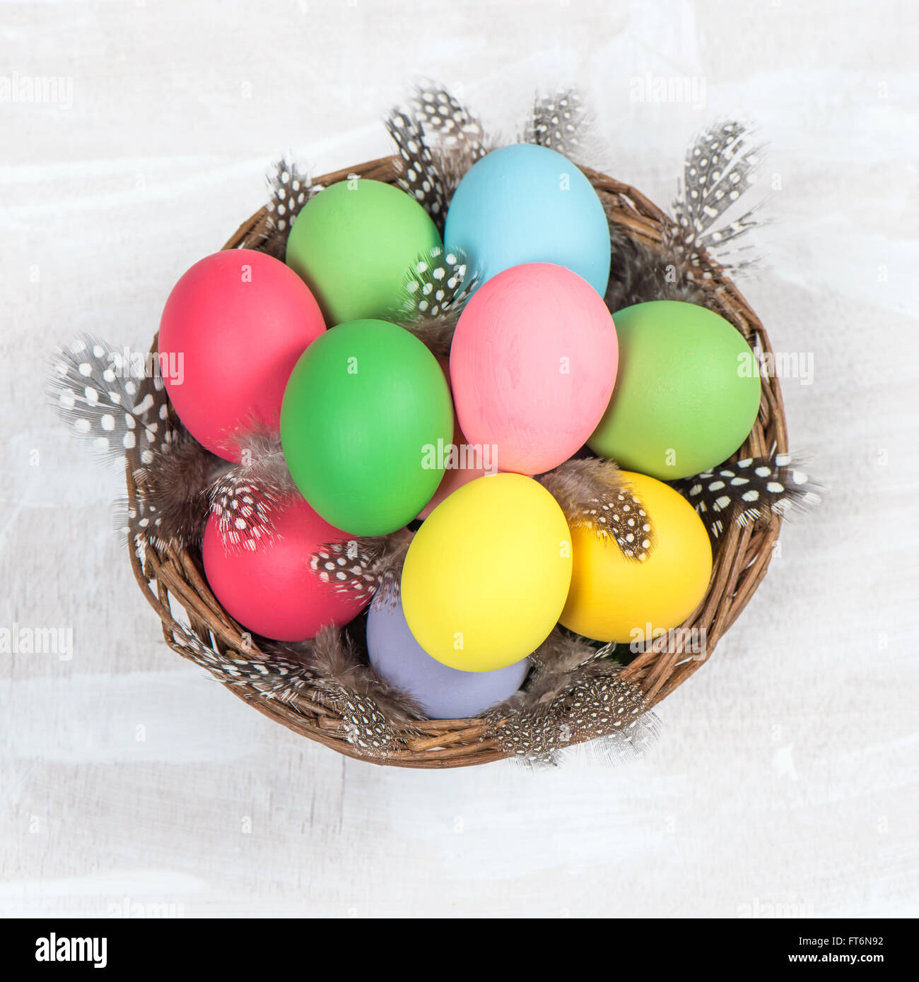 Colorful Easter eggs in basket. Top view Stock Photo - Alamy