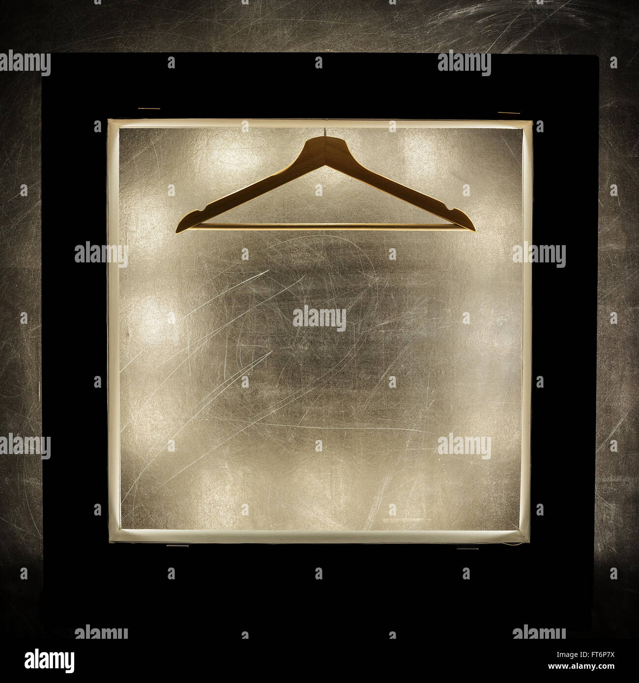 Wooden hanger on bright background with spot lights Stock Photo - Alamy