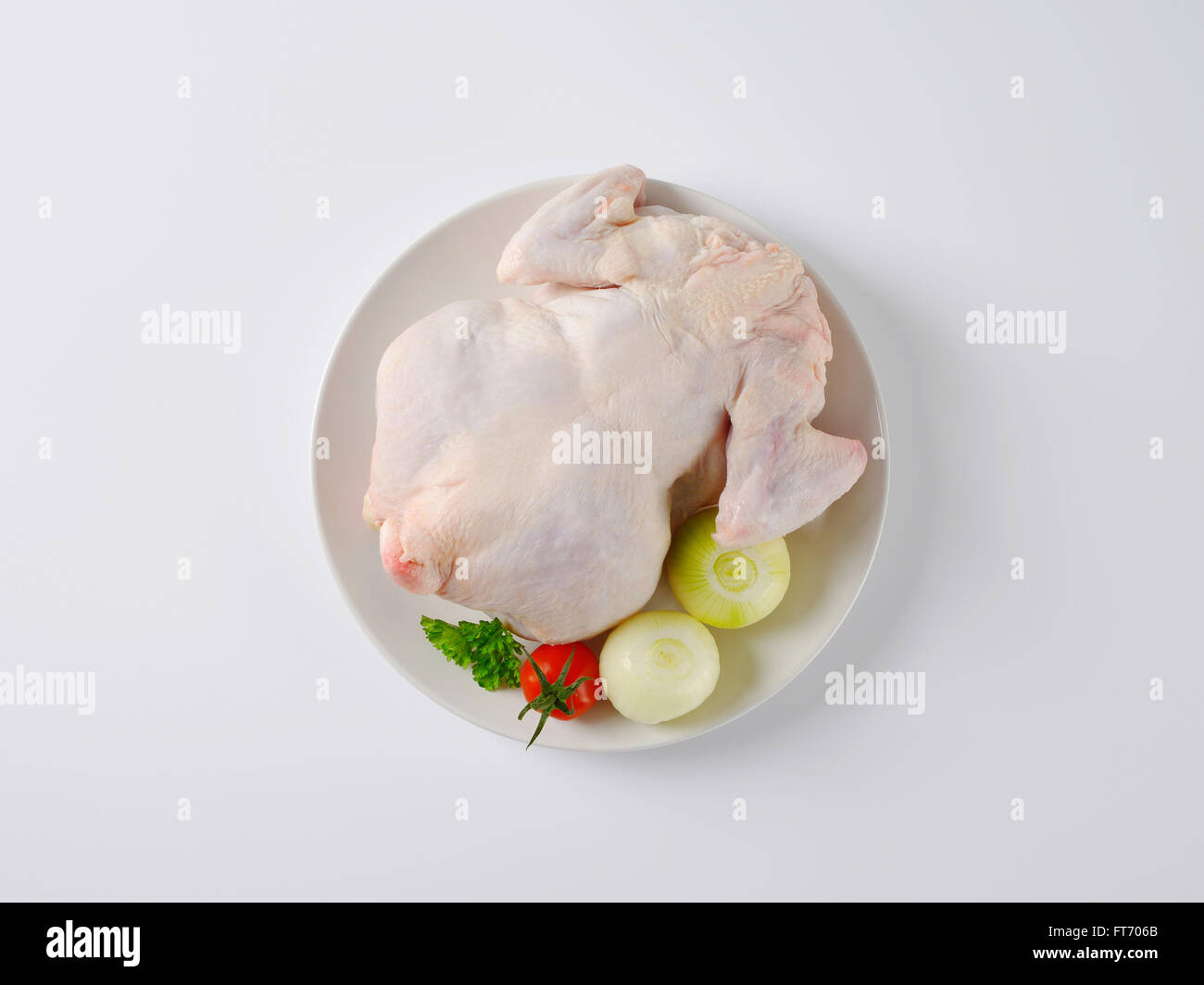 overhead view of raw chicken with vegetables on plate Stock Photo - Alamy
