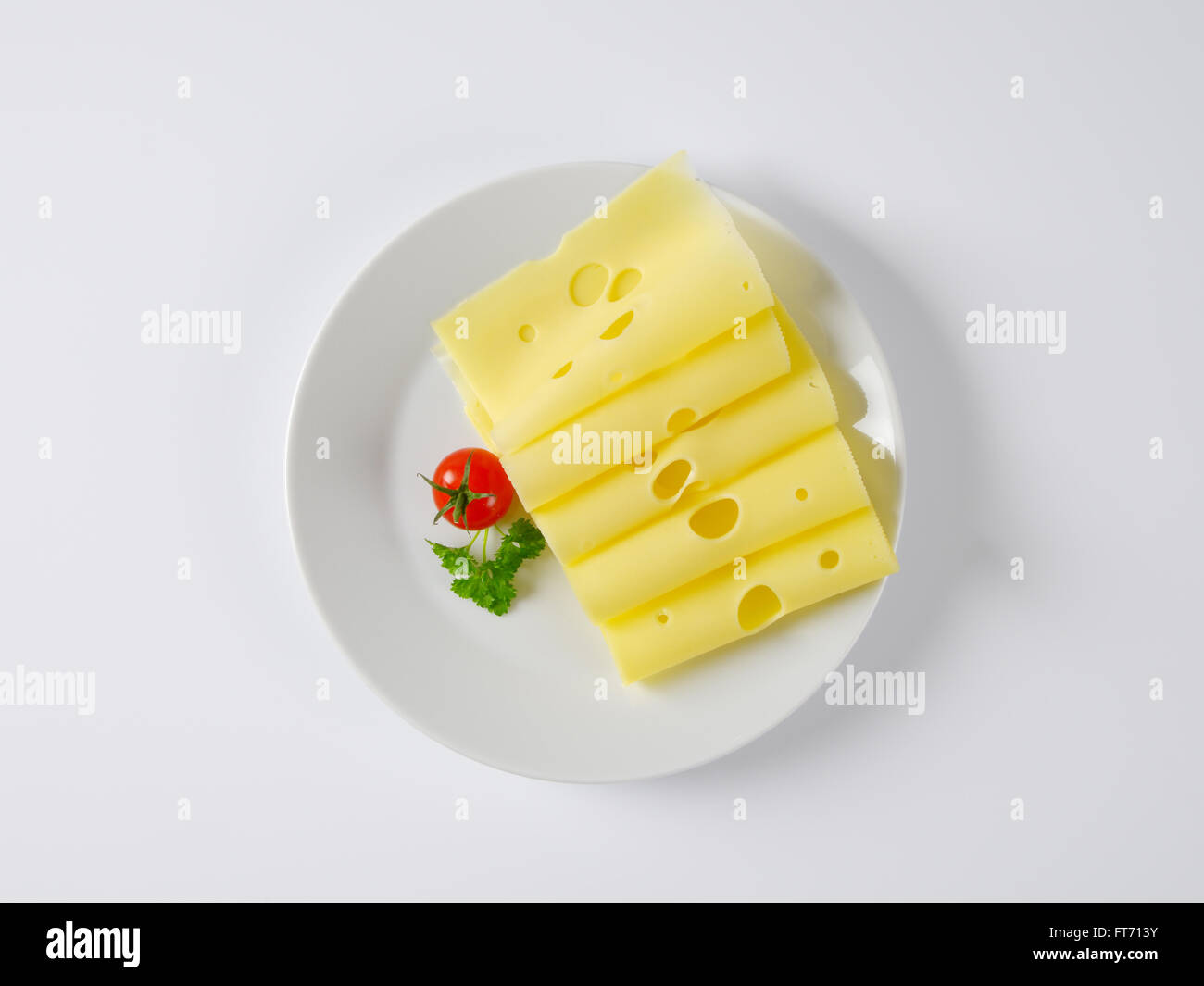 sliced Swiss cheese on plate Stock Photo - Alamy