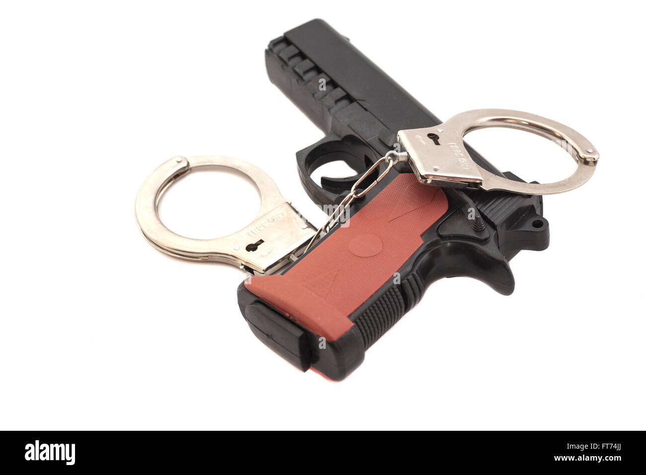Gun and handcuffs isolated on white background Stock Photo - Alamy