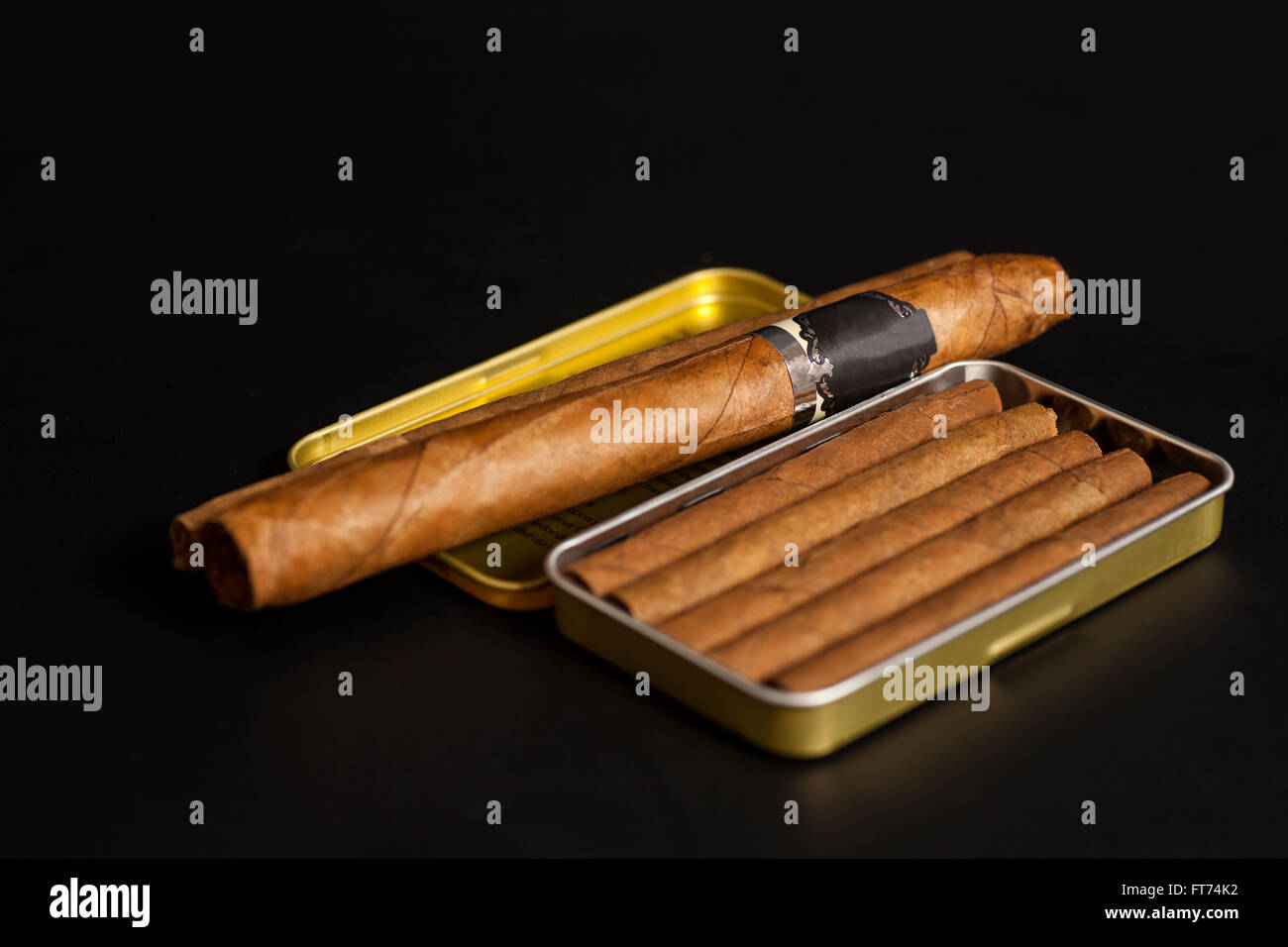 Open metal cigar box and cuban cigars on black background Stock Photo ...