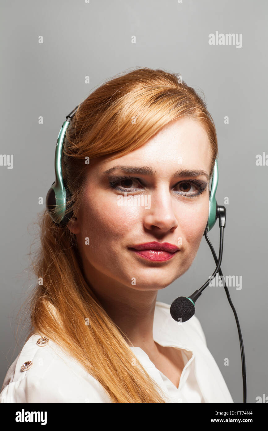 Female customer support operator with headset and smiling isolated on gray background Stock ...