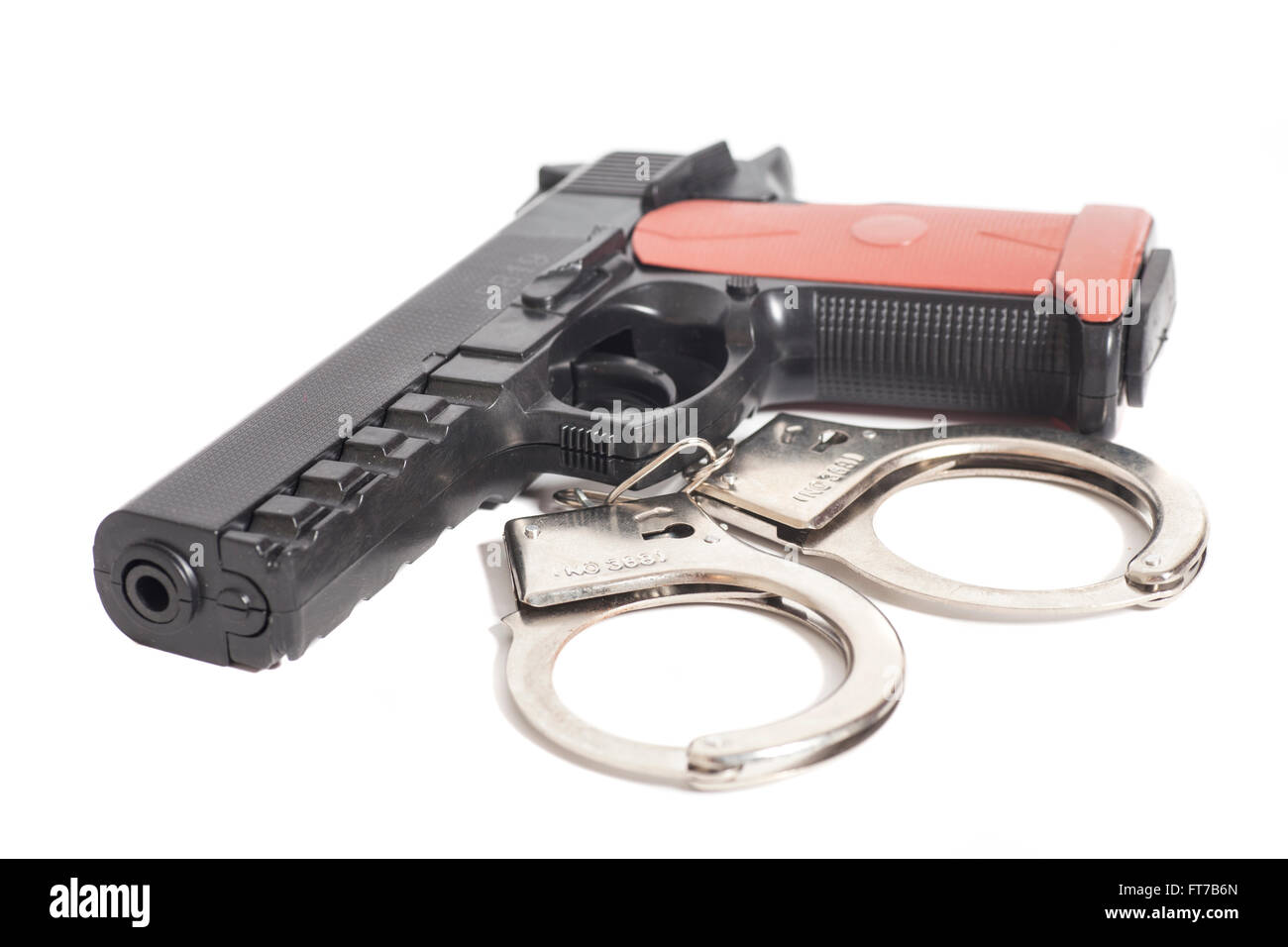 Gun and handcuffs isolated on white background Stock Photo - Alamy