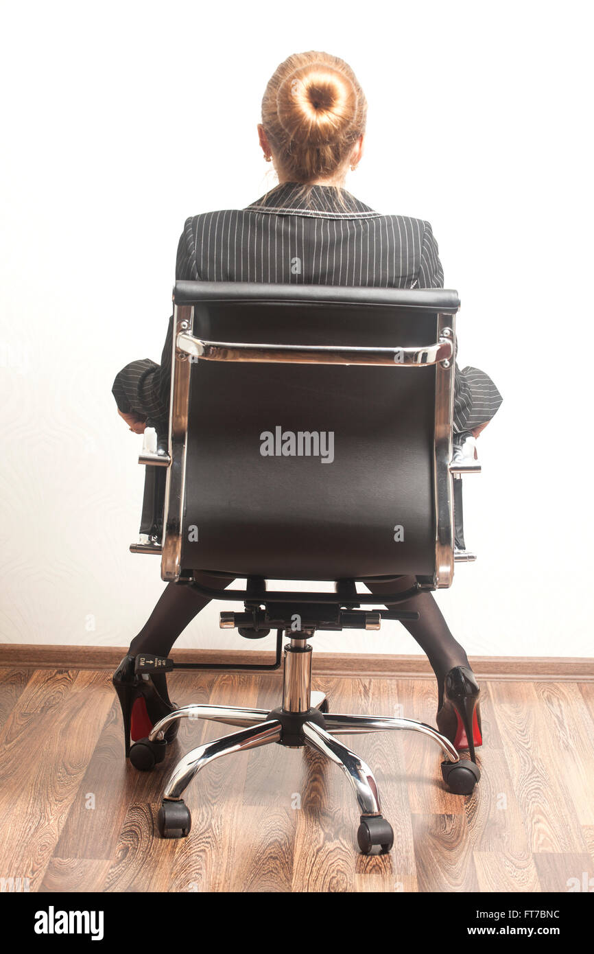 Back view woman siting on armchair in office Stock Photo - Alamy