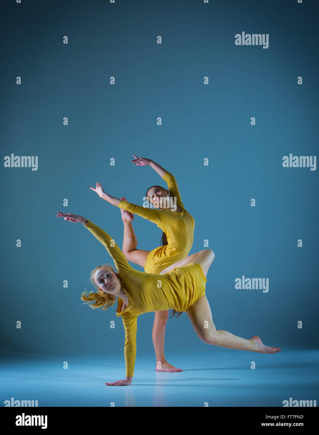 The two modern ballet dancers dancing on gray background Stock Photo ...