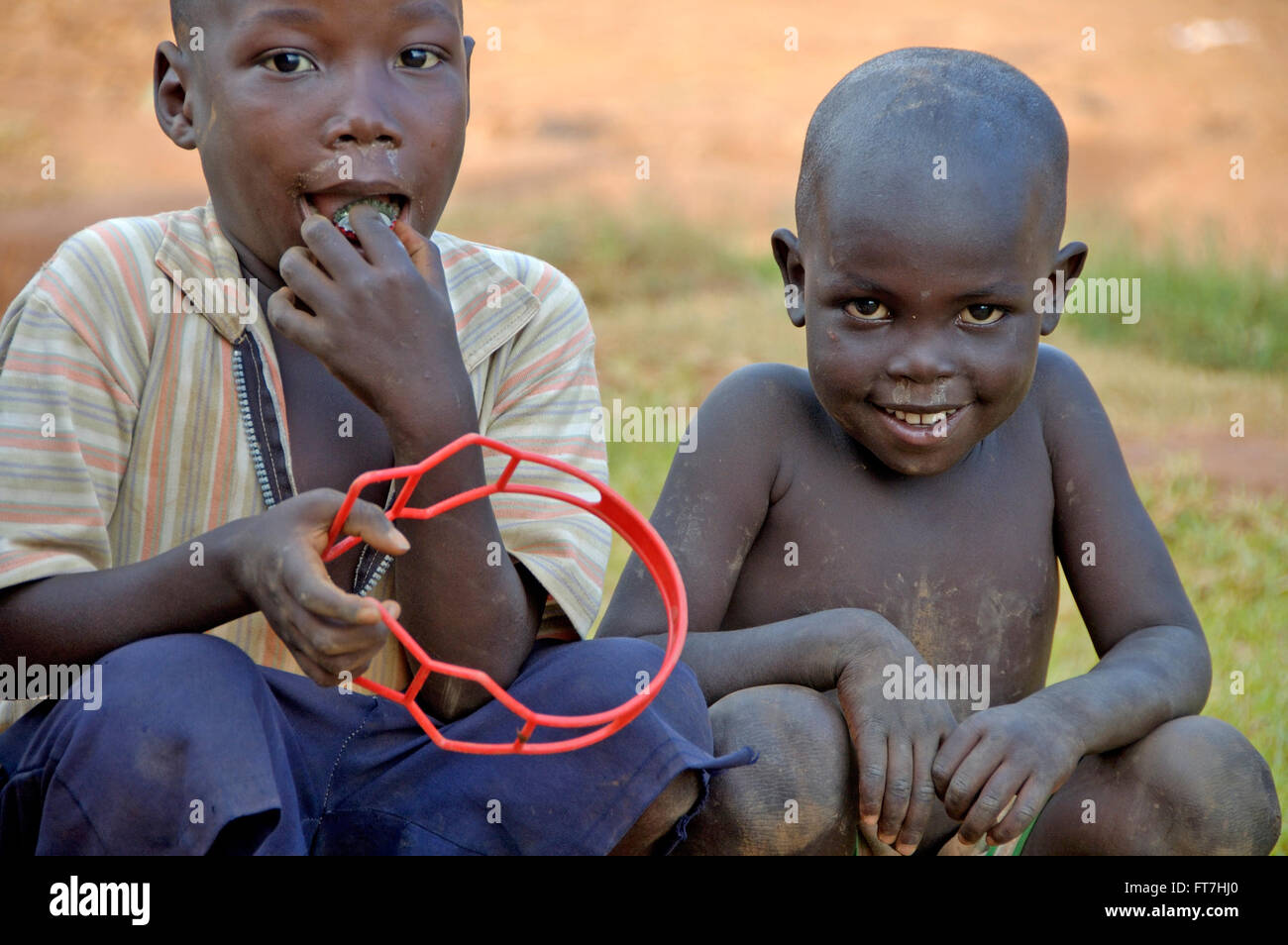 Kampala, Uganda-10 April 2007: Unidentified child is chewing on a top ...