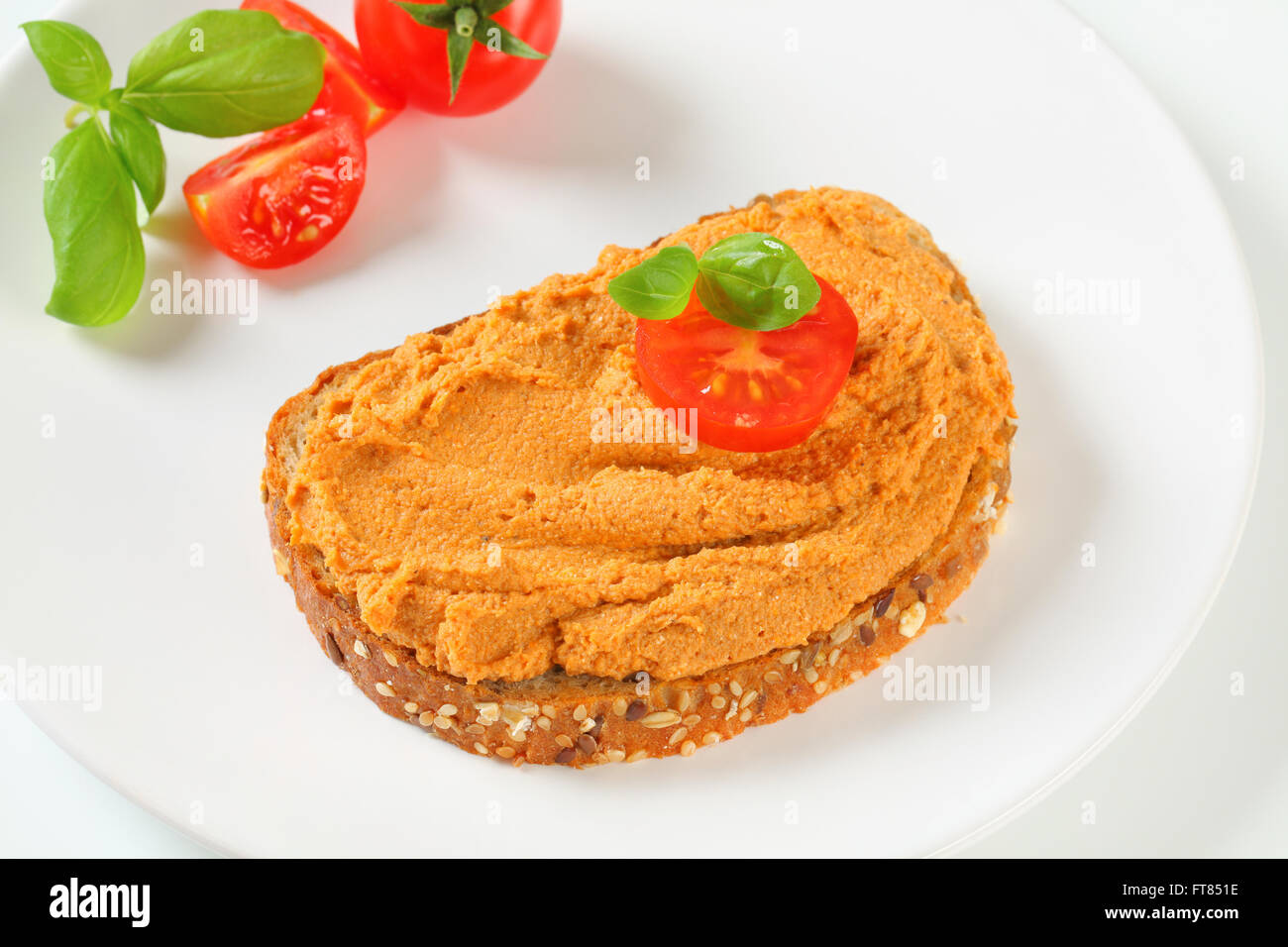 Slice of bread with hummus Stock Photo - Alamy