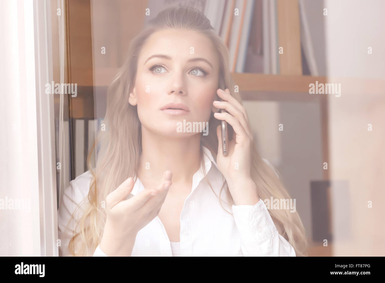 Portrait of beautiful serious business woman speaking on the phone and ...