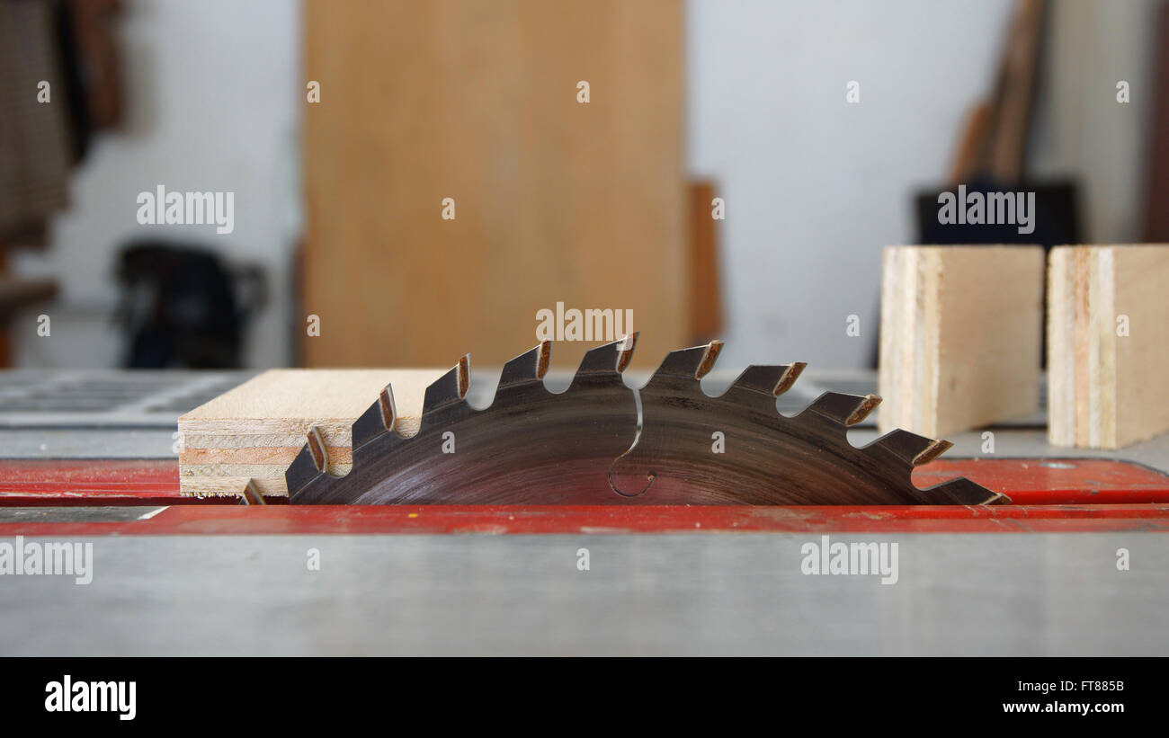 Table saw cutting a small wooden table in the carpentry / front view ...
