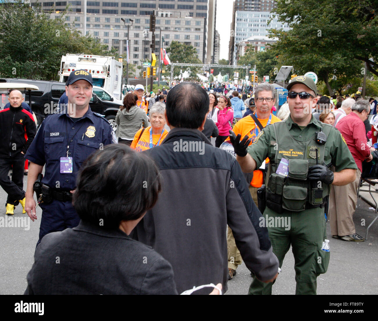 U.S. Customs and Border Protection officers assist pilgrims near ...