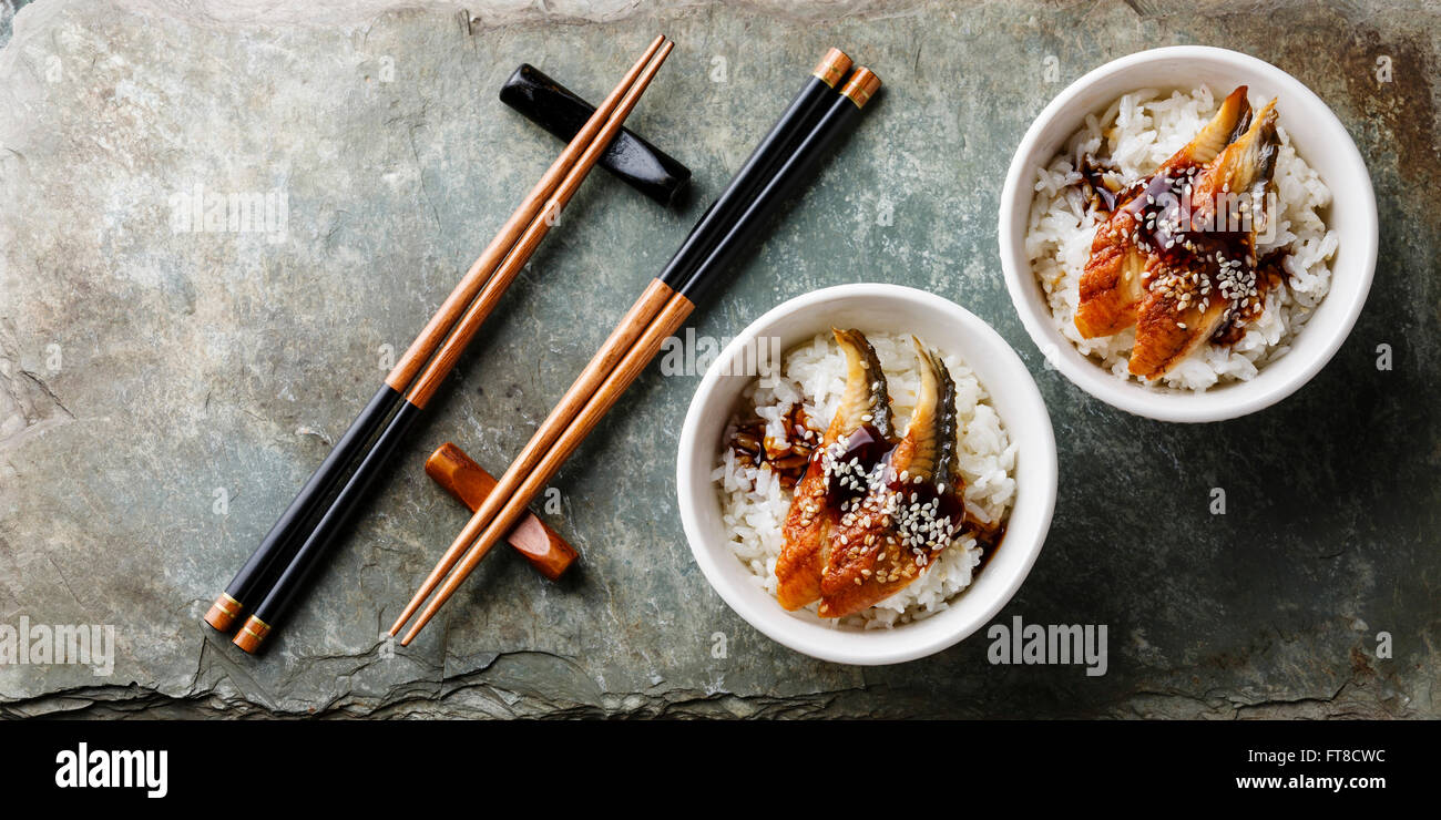 Eel on Rice with sauce and sesame served for two on stone slate ...