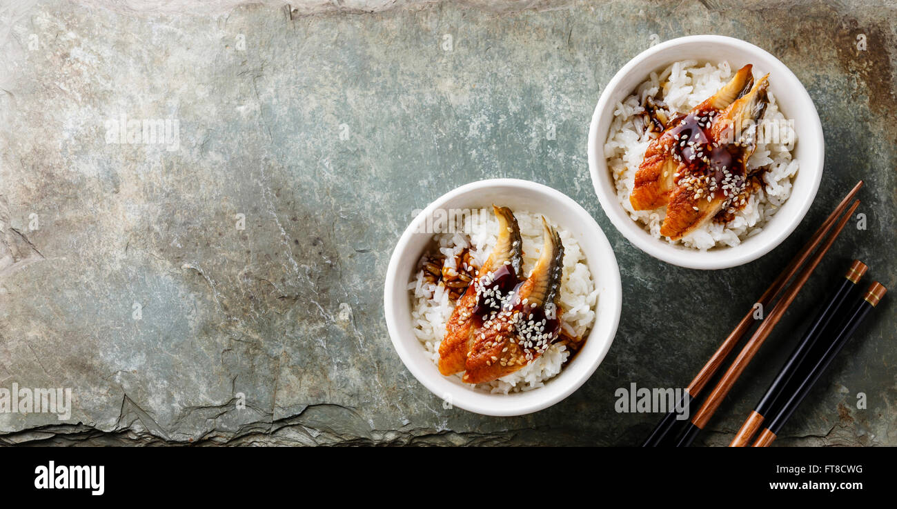Eel on Rice with sauce and sesame served for two on stone slate ...