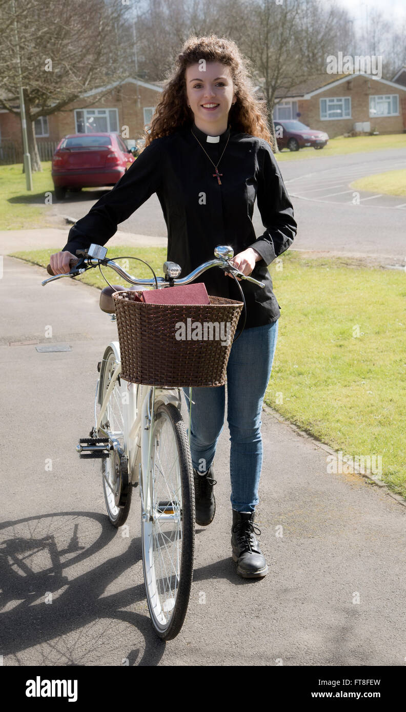 Young vicar walking around her country parish Stock Photo - Alamy
