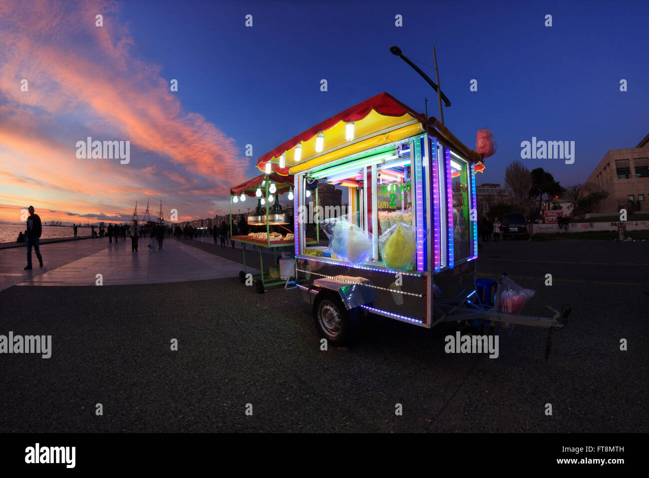 Portable vintage candyfloss retractable concession cart lit at twilight ...