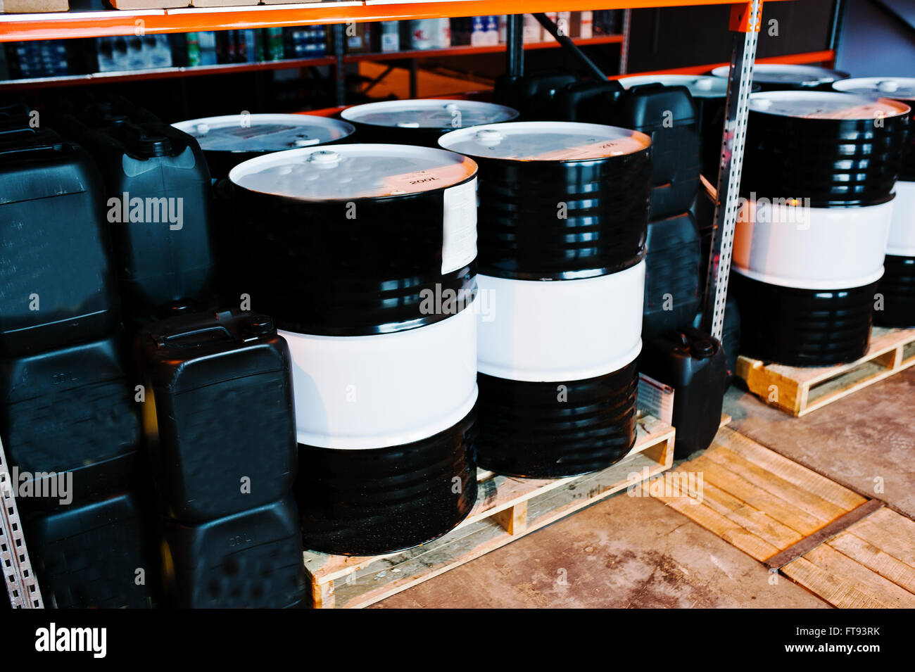 Barrels and cans of motor oil on shelves Stock Photo - Alamy
