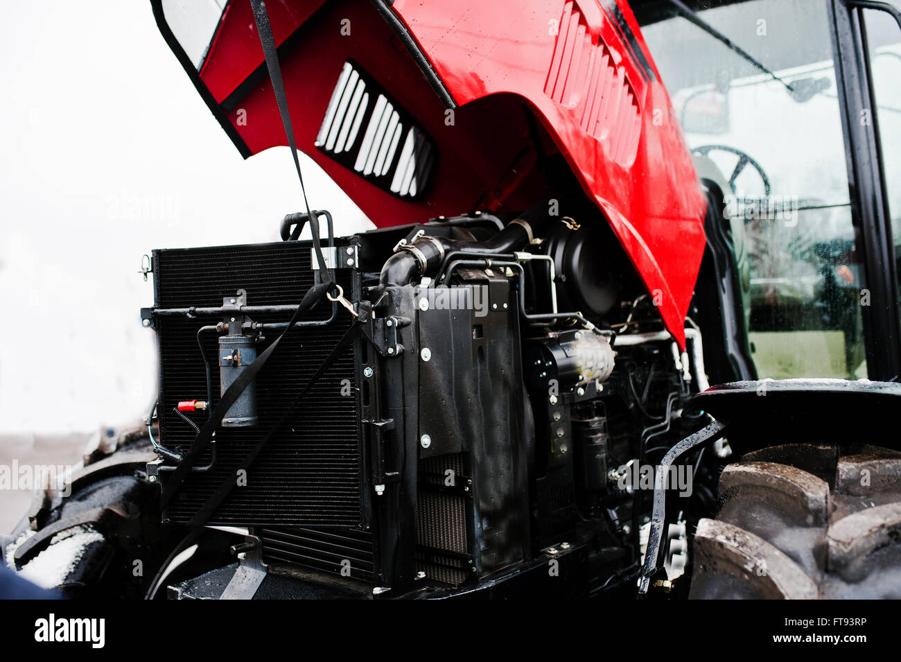 Close up in front of the new red tractor with open motor Stock Photo ...