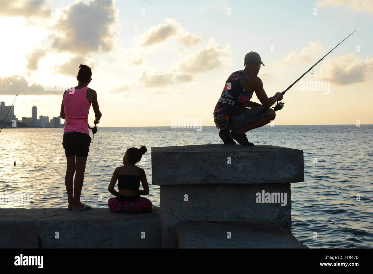 Young men fishing from the Malecon, Havana Stock Photo - Alamy