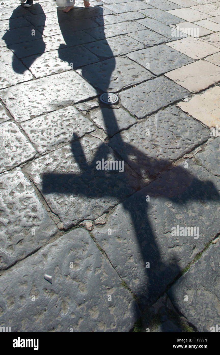 Barletta, Italy. 25th Mar, 2016. Shadow of Penitents carries a wooden ...