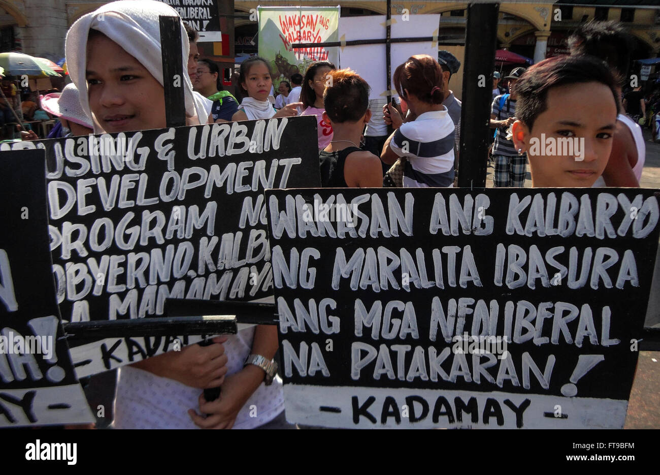 Manila, Philippines. 21st Mar, 2016. Protesters hold placards placed on ...