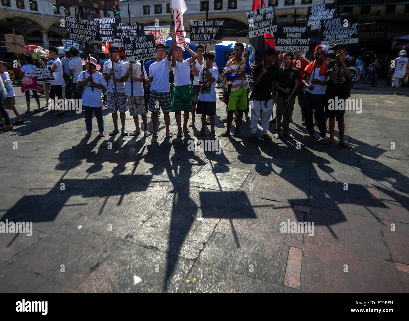 Manila, Philippines. 21st Mar, 2016. Protesters hold placards placed on ...