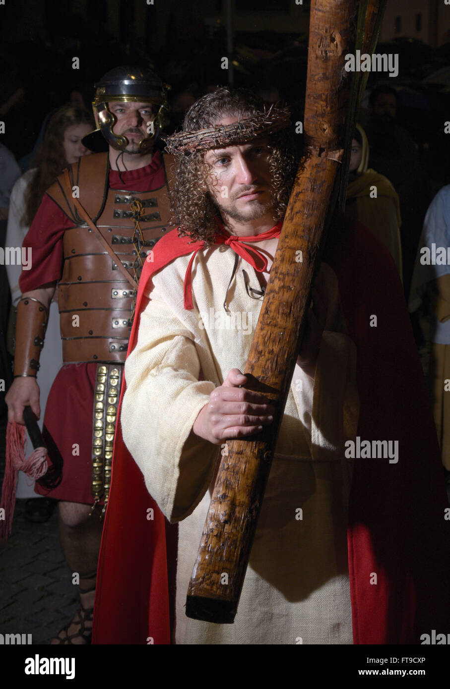 A Jesus impersonator carries a cross through Ulm, Germany, 25 March ...