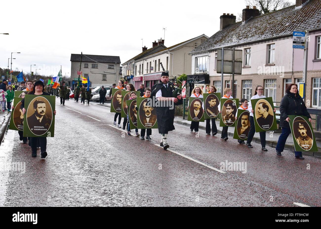 Coalisland, United Kingdom. 26th Mar, 2016. Marchers hold placards ...