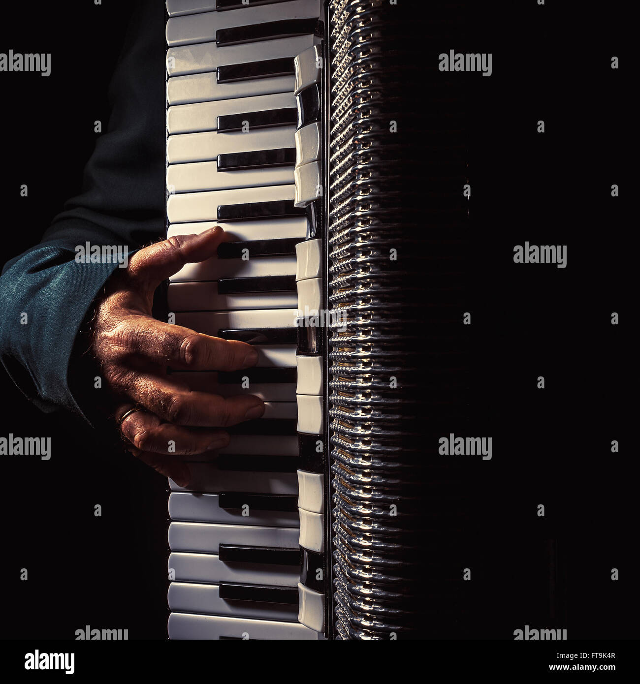 Conceptual composition about playing an accordion, details of a hand on ...