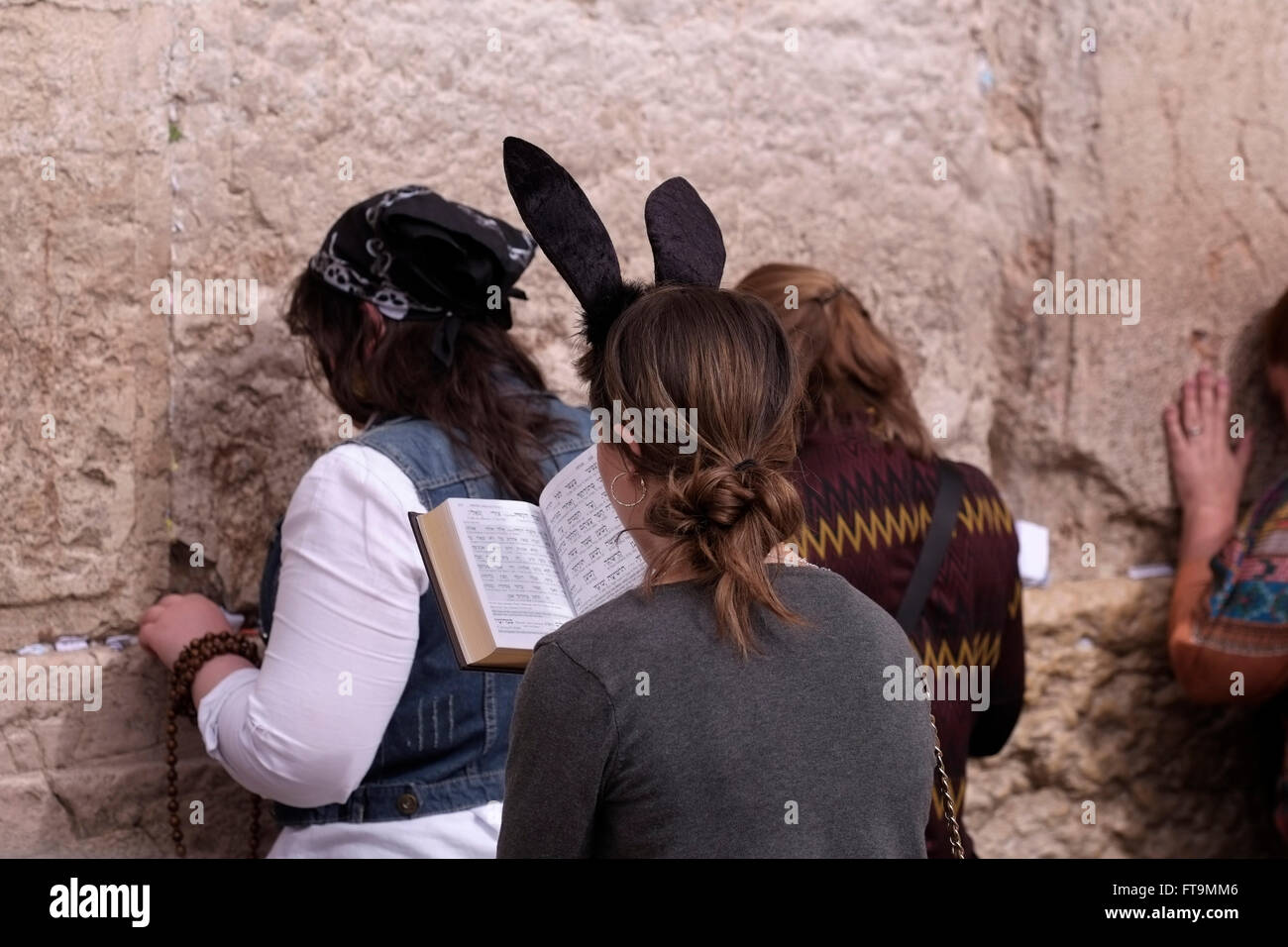 Religious Jewish woman wearing bunny ears praying during the Jewish ...