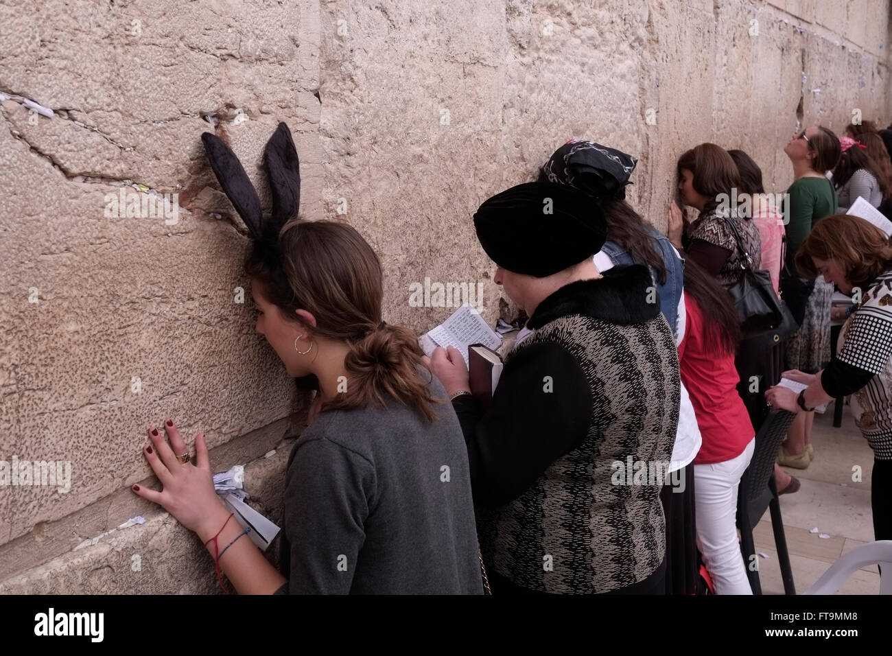 A Jewish woman wearing bunny ears costume praying during the Jewish ...