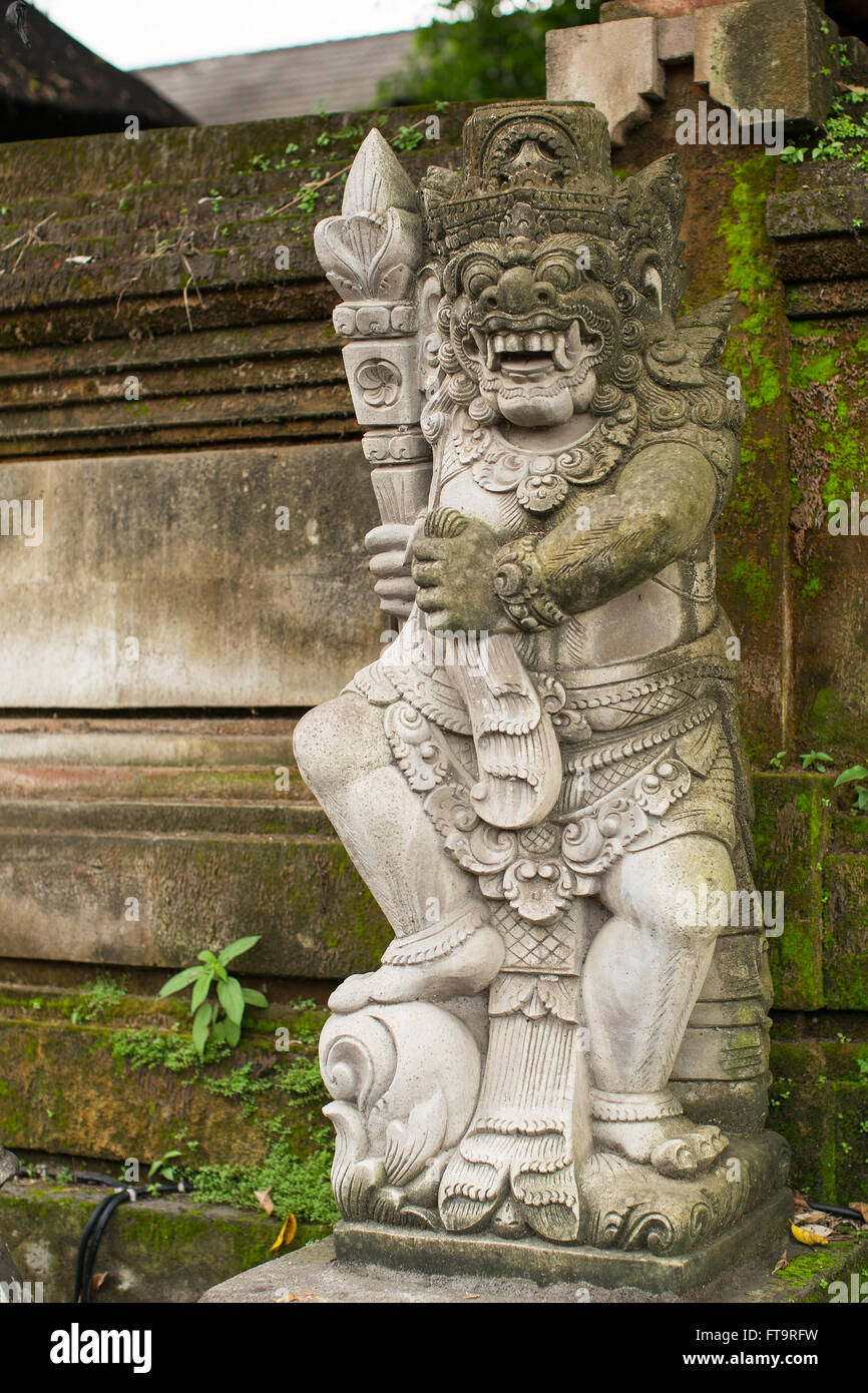 Traditional demon guard statue carved in stone on Bali, Indonesia Stock ...