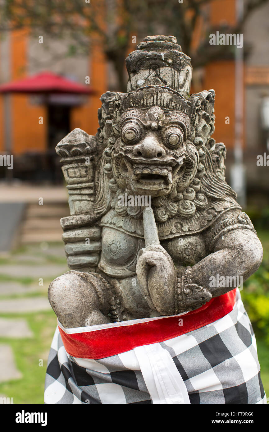 Traditional demon guard statue carved in stone on Bali, Indonesia Stock ...