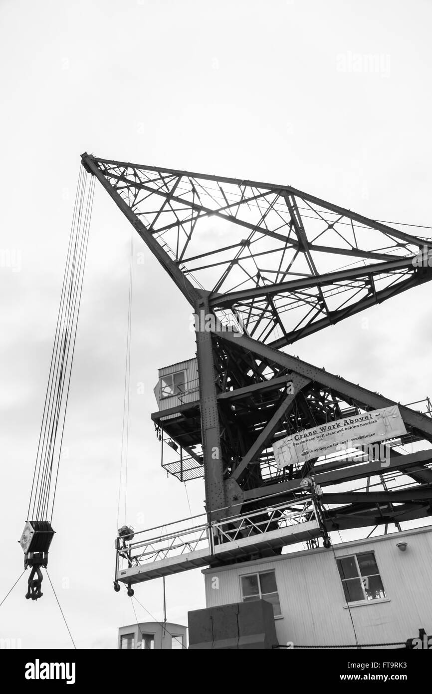 Large crane from low angle with safety warning sign Crane Work Above ...