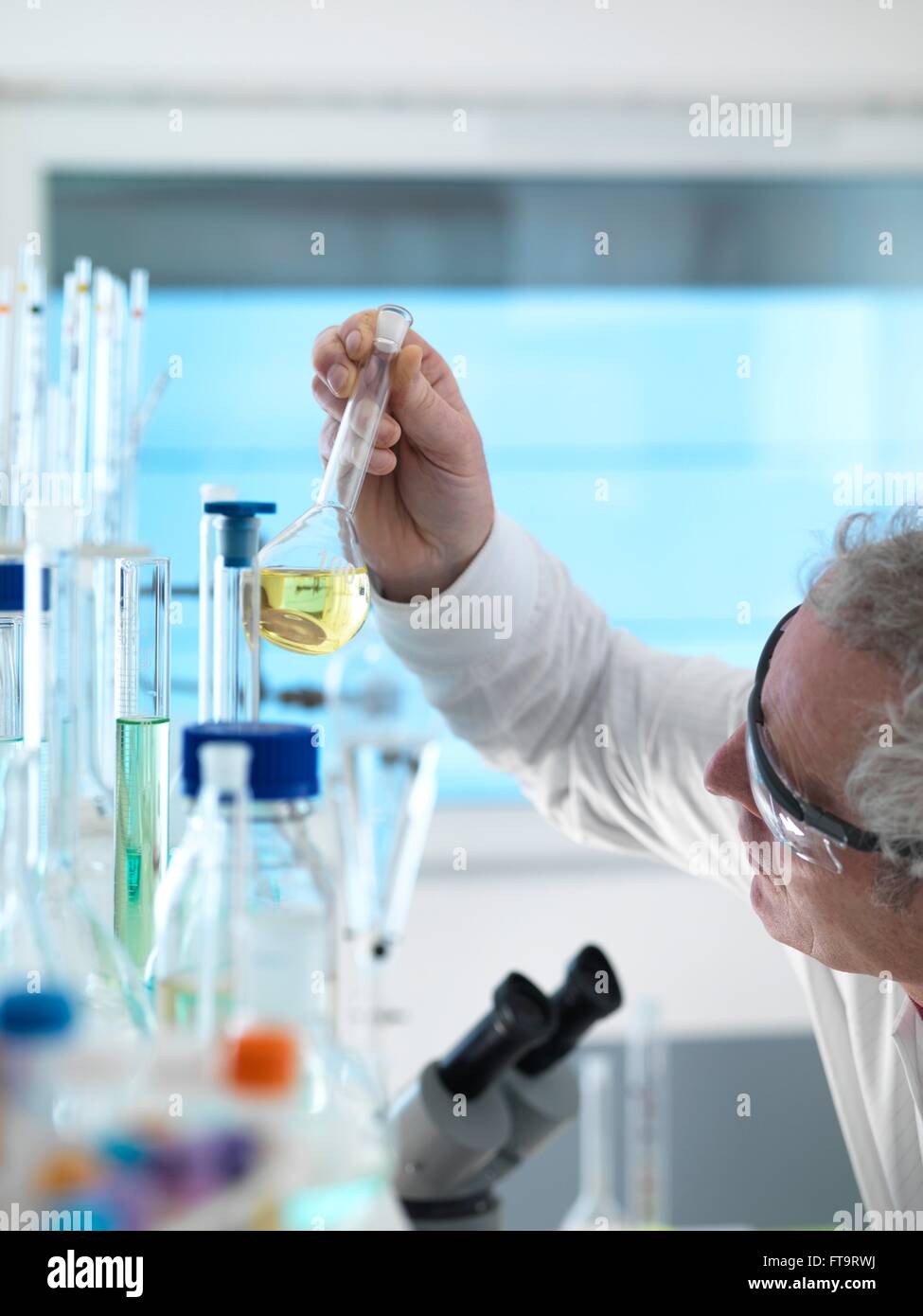 PROPERTY RELEASED. MODEL RELEASED. Scientist holding a chemical ...